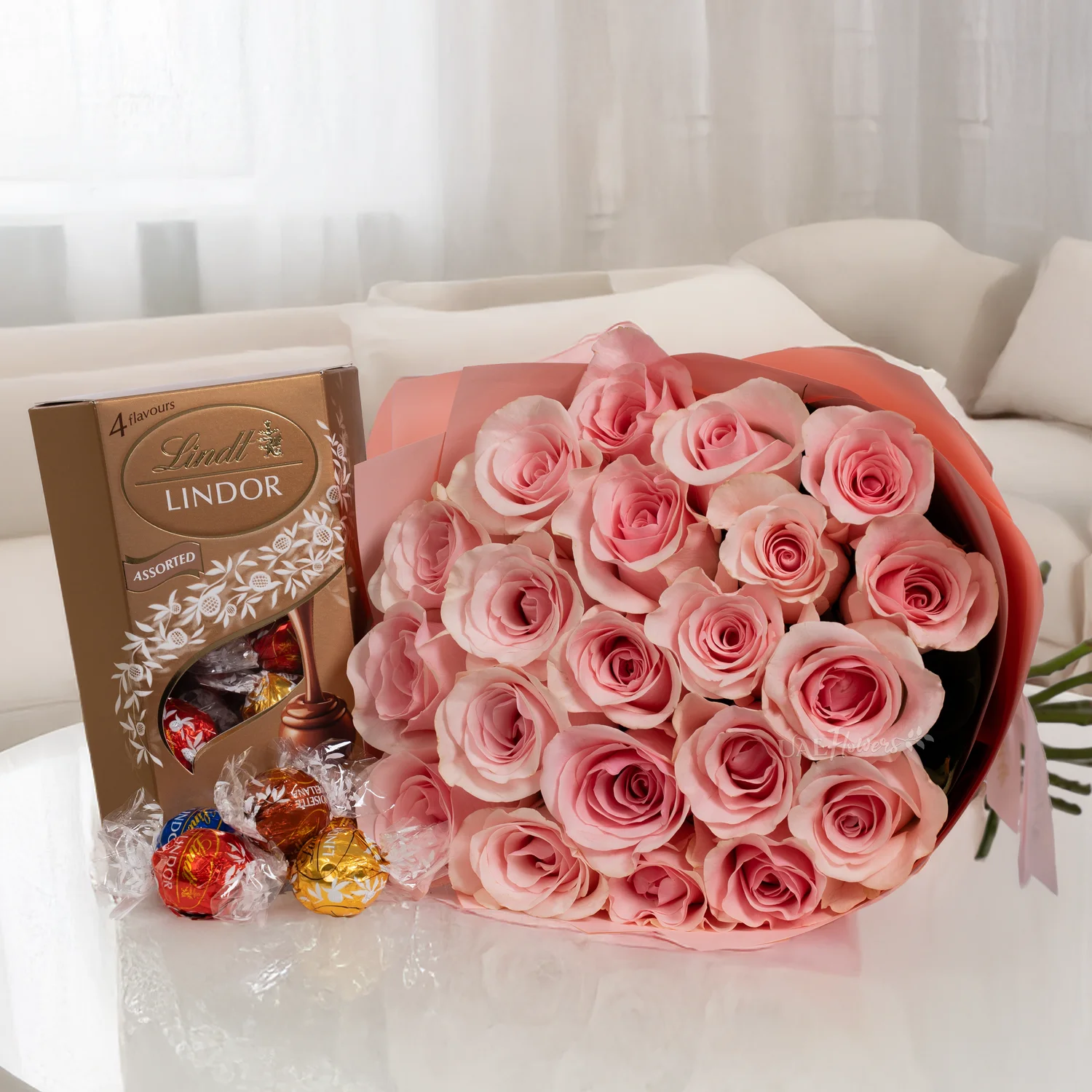 Gift Combo of Pink Roses and Lindt Chocolates By UAE Flowers